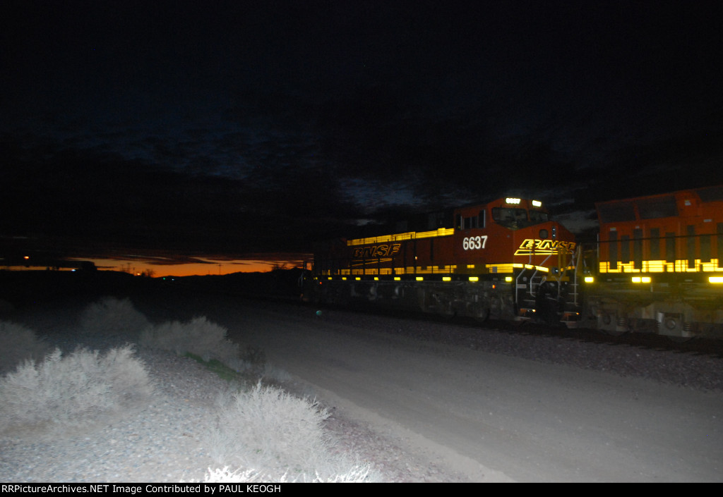 BNSF 6637 at sunset as she reflects her BNSF Swoosh logo as the 2d Rear DPU on a eastbound Z-Train